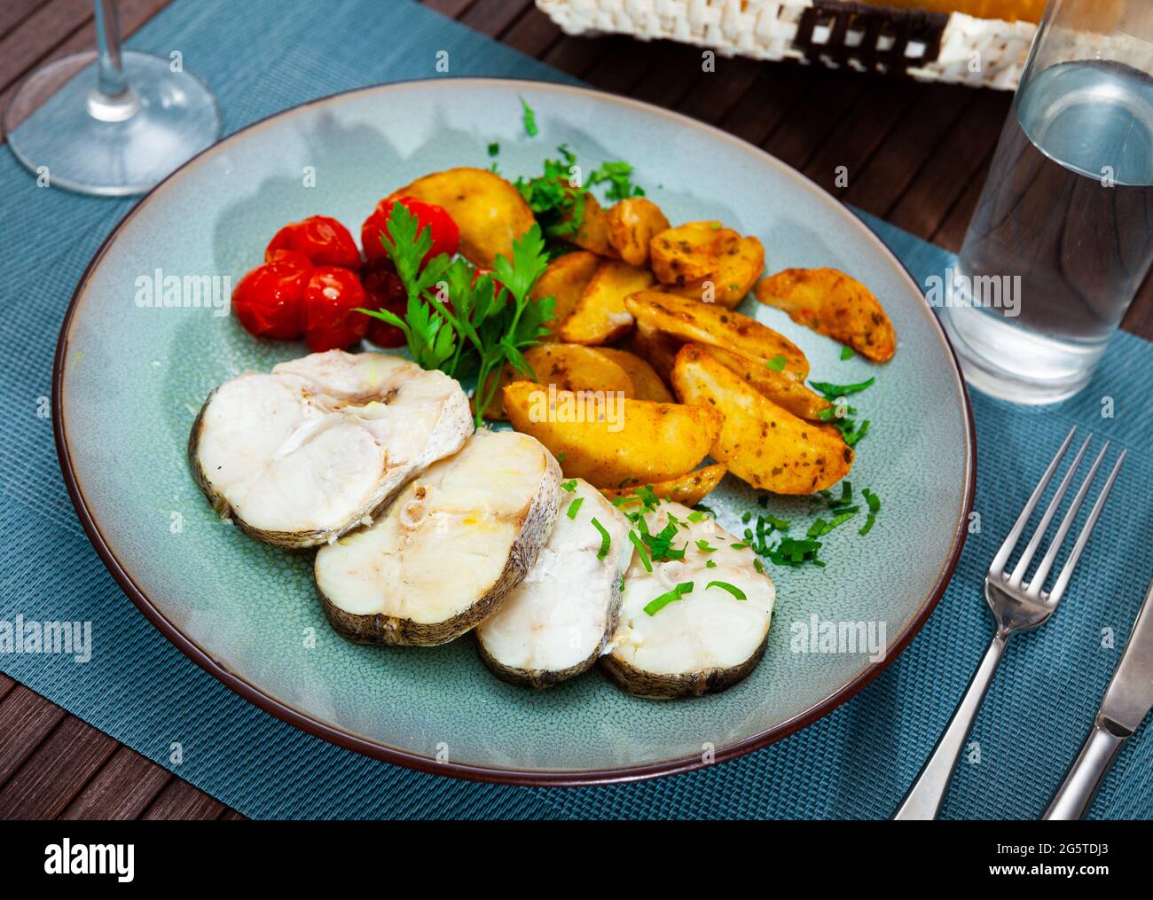 Baked hake steaks with vegetable side dish Stock Photo - Alamy
