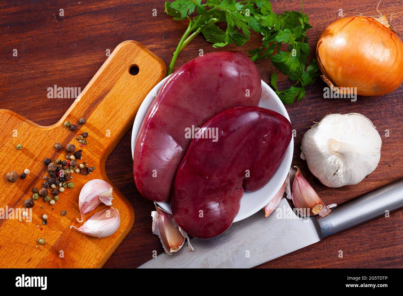 Raw pork kidneys on wooden table Stock Photo - Alamy