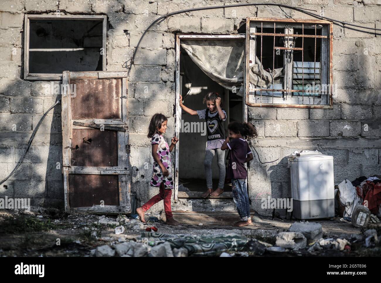 Palestinian children play in front of their house on a sunny day in ...