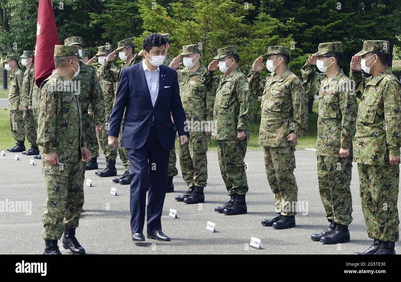Japanese Defense Minister Nobuo Kishi (C) visits a Ground Self-Defense Force base in Chitose in ...