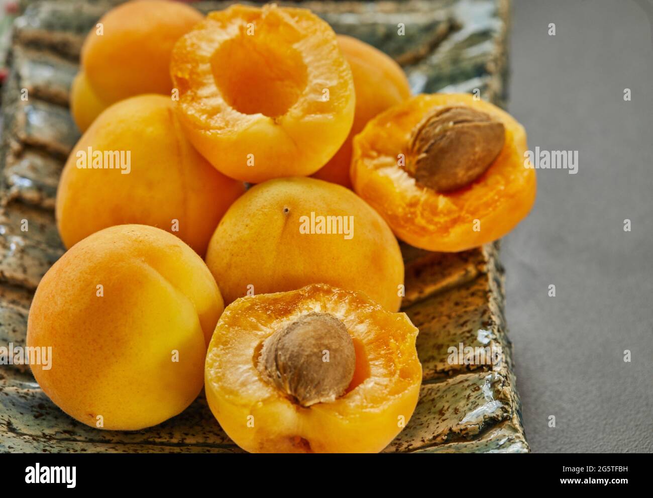 Fresh apricots whole and cut in half with seeds, ready to eat Stock ...