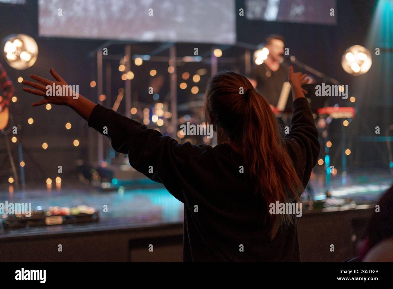 Audience at live music concert with arms raised dancing at night Stock ...
