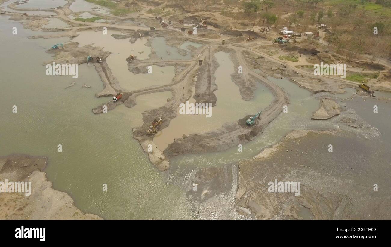 Aerial view excavator and heavy equipment, dredging and deepening the ...