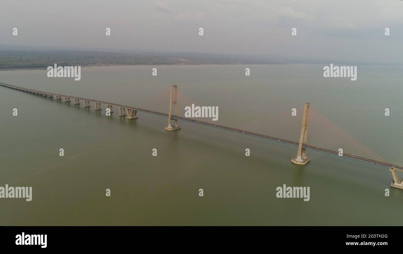 suspension bridge over madura strait with highway and car, surabaya ...