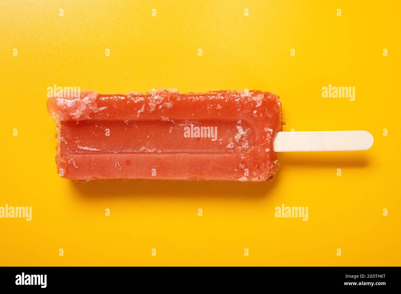 top view fresh red popsicle on a yellow background Stock Photo - Alamy