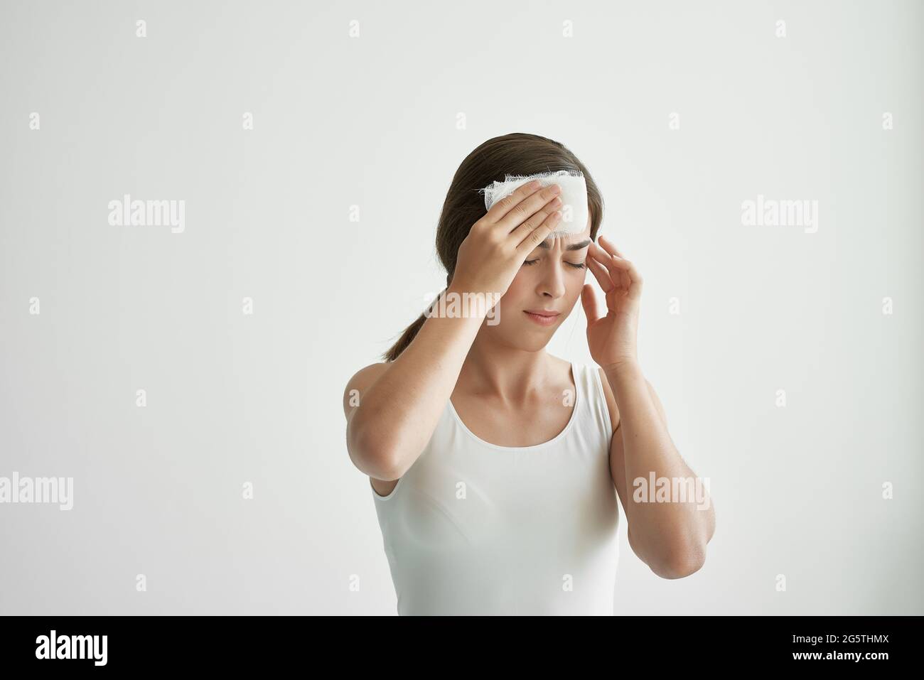woman in white t-shirt wipes her face with a handkerchief fever health ...
