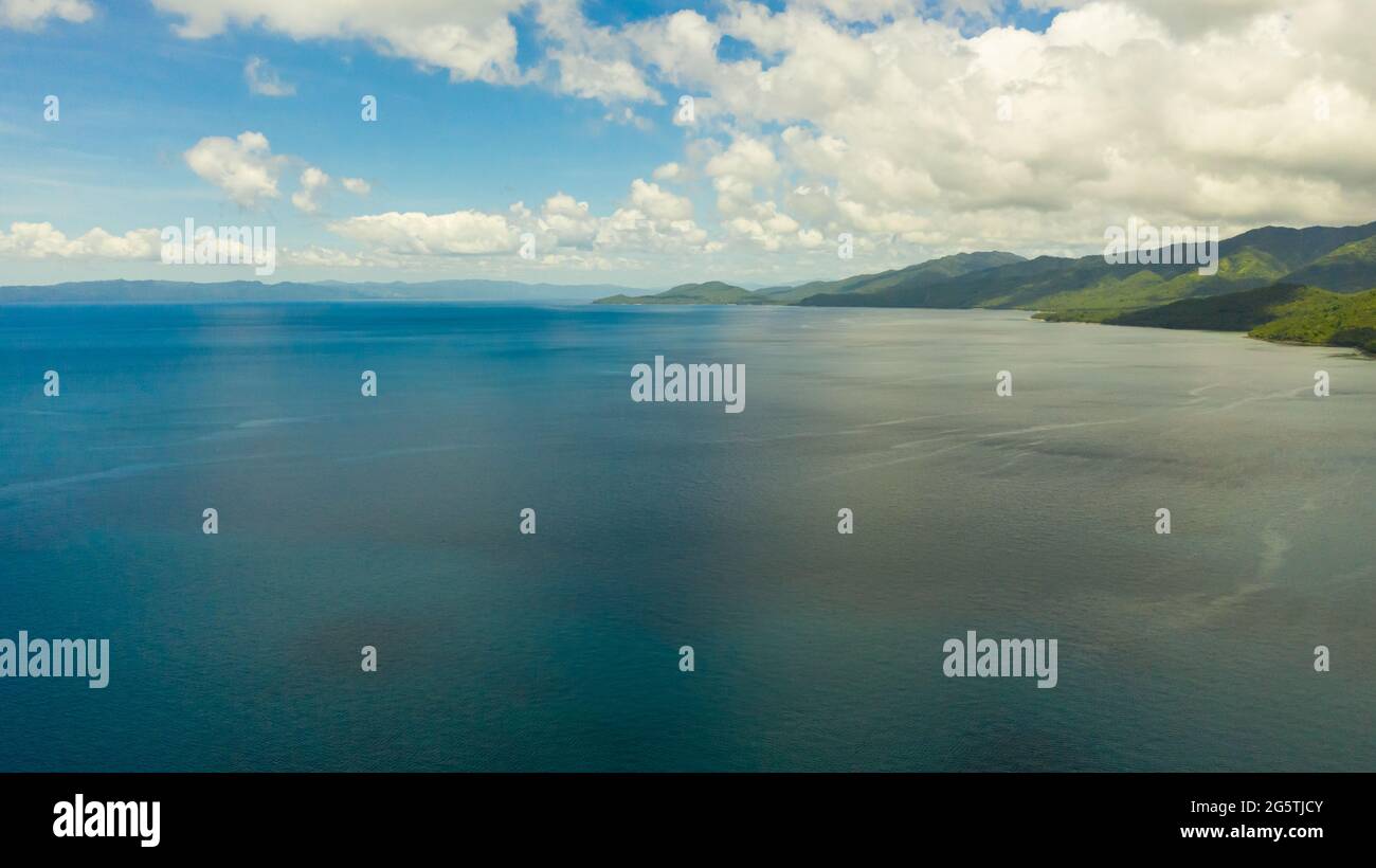 Aerial view of mountains and hills with tropical forest with blue sea ...