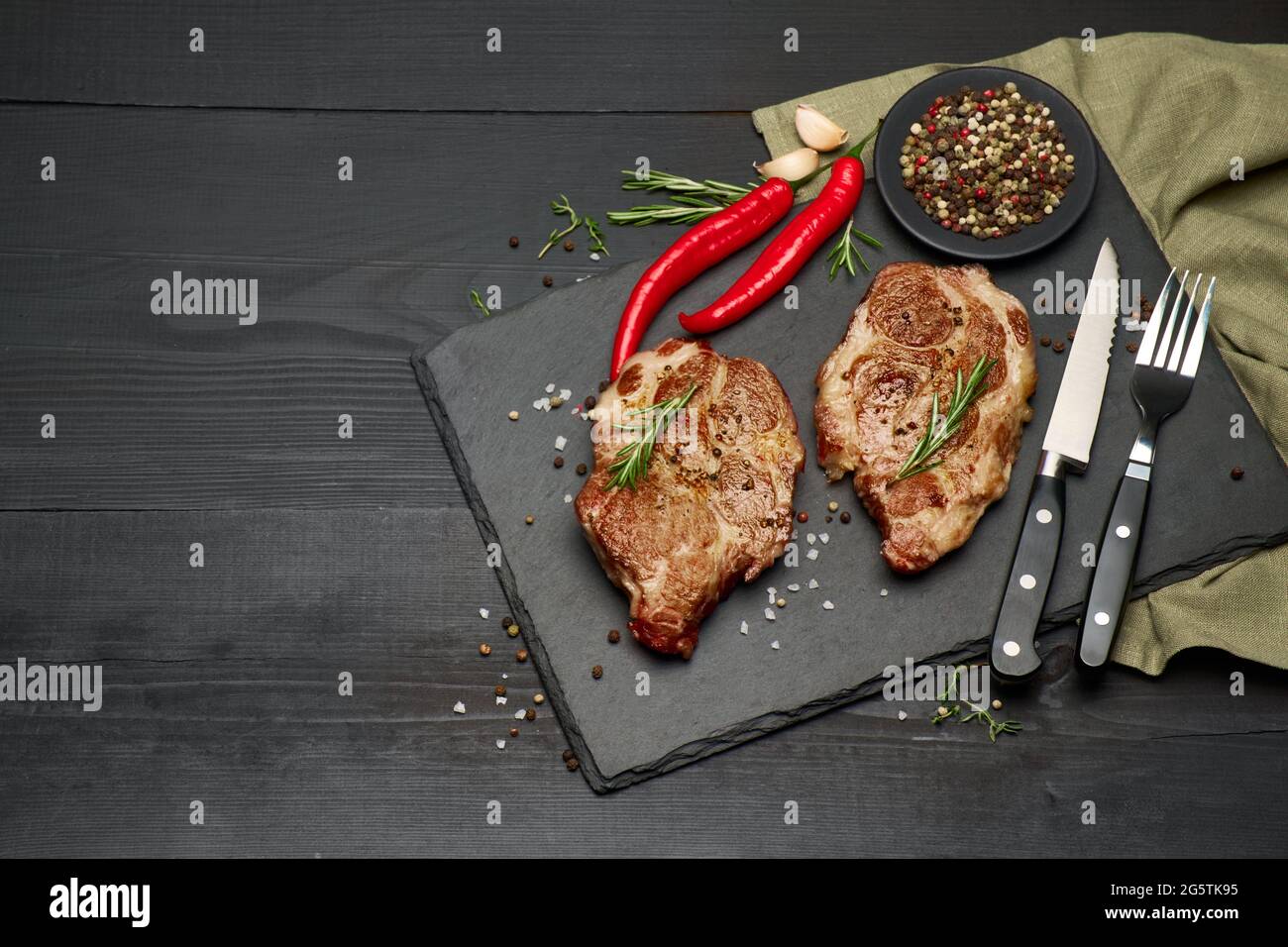 Grilled roated beef steaks on stone serving cutting board Stock Photo ...