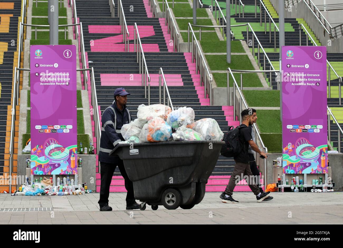 London, UK. 29th June, 2021. A worker collects rubbish left by football ...