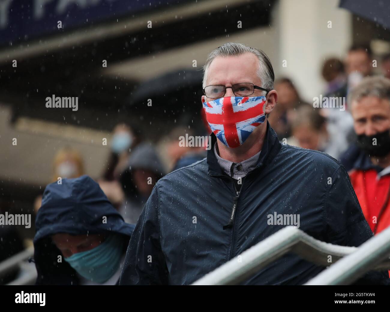 London, UK. 29th June, 2021. A football fan with Union Jack face mask ...