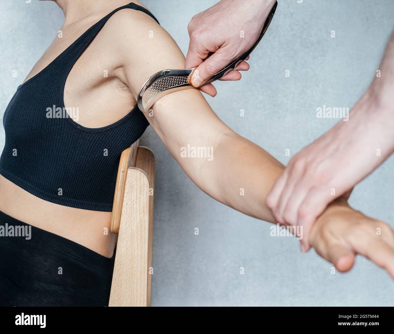 IASTM treatment for myofascial restriction, a woman receiving soft ...