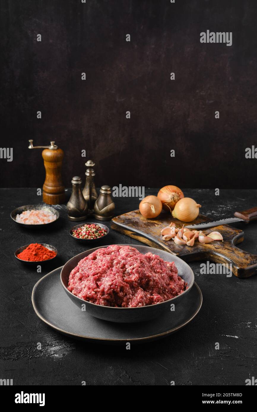 Raw ground beef forcemeat in a bowl on dark background Stock Photo - Alamy
