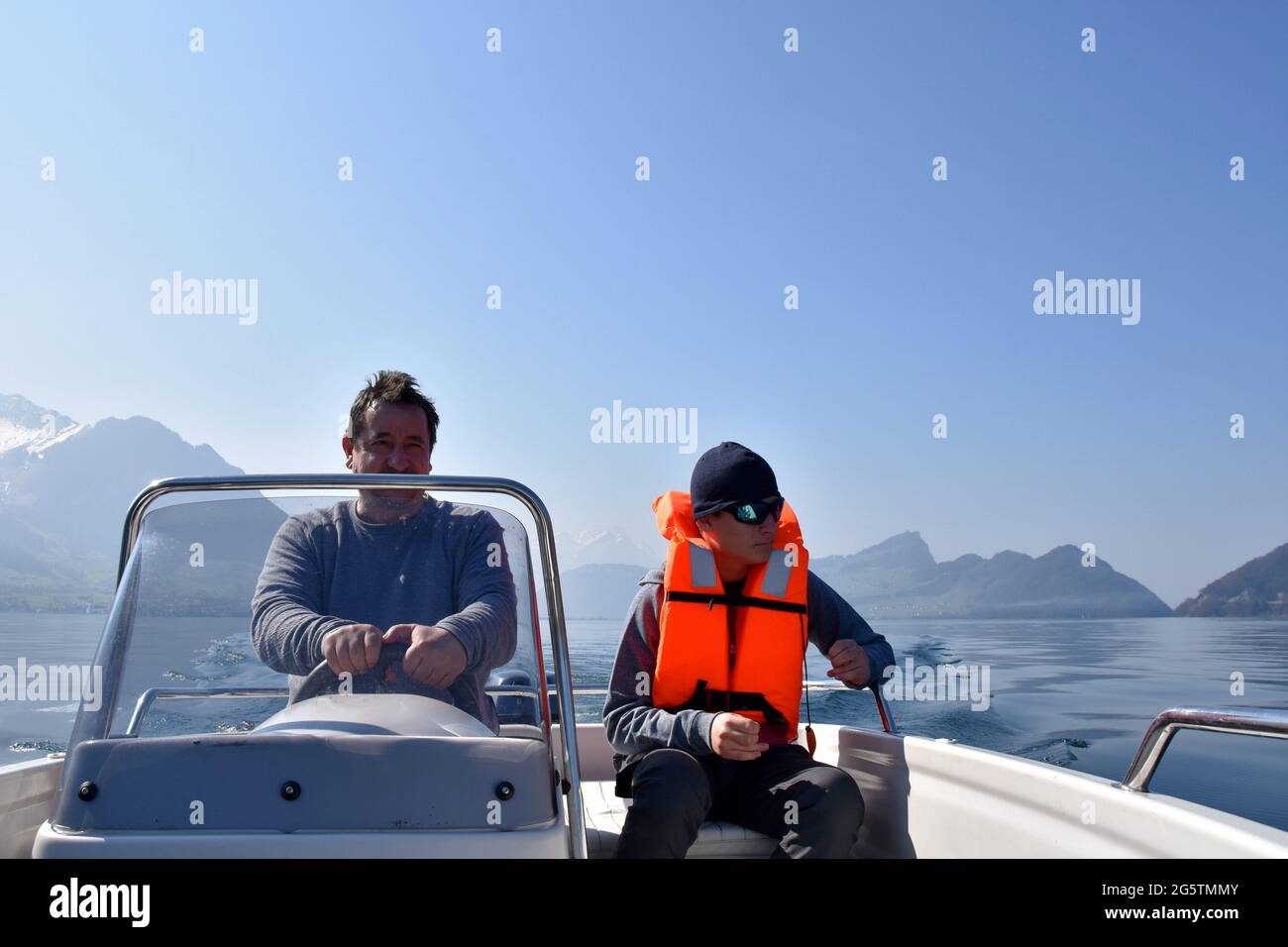 Father son driving motorboat hi-res stock photography and images - Alamy