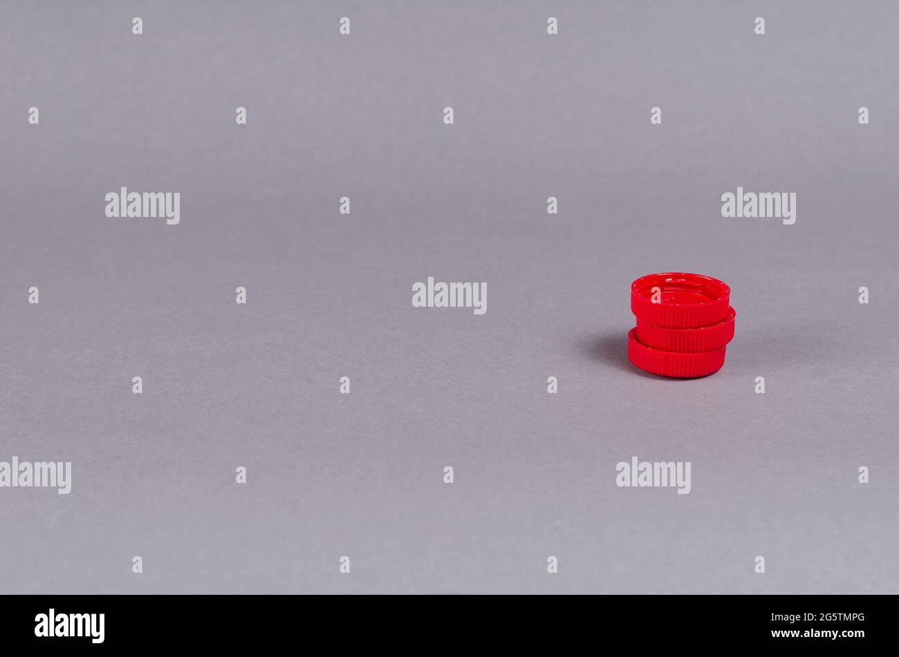 Red bottle stoppers gainsboro background. Minimalist composition with ...