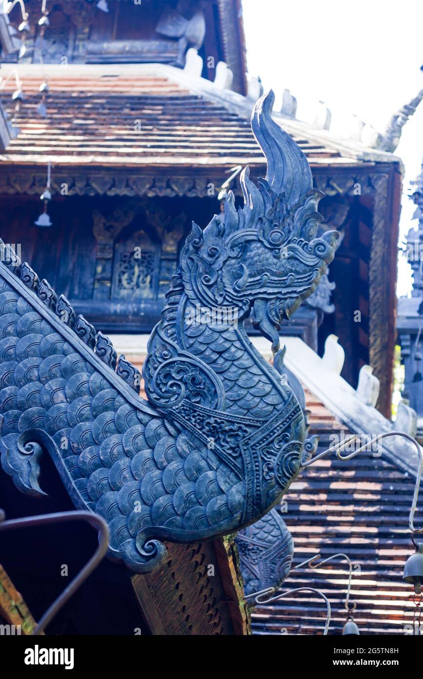 The head of a carved black wood serpent was used to decorate the roof ...