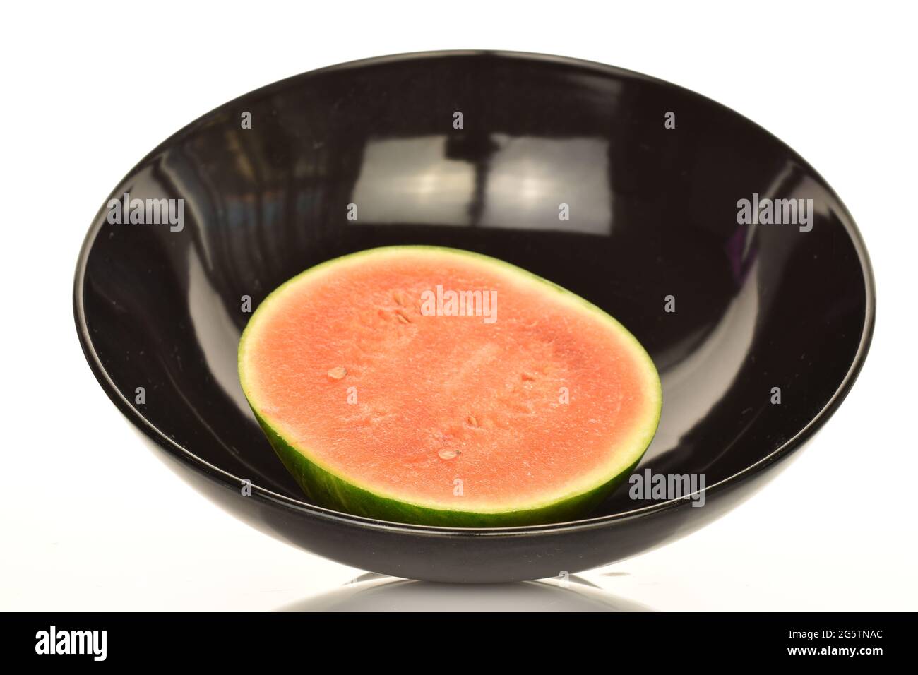 One half of a juicy watermelon in a black ceramic plate, close-up, on a ...