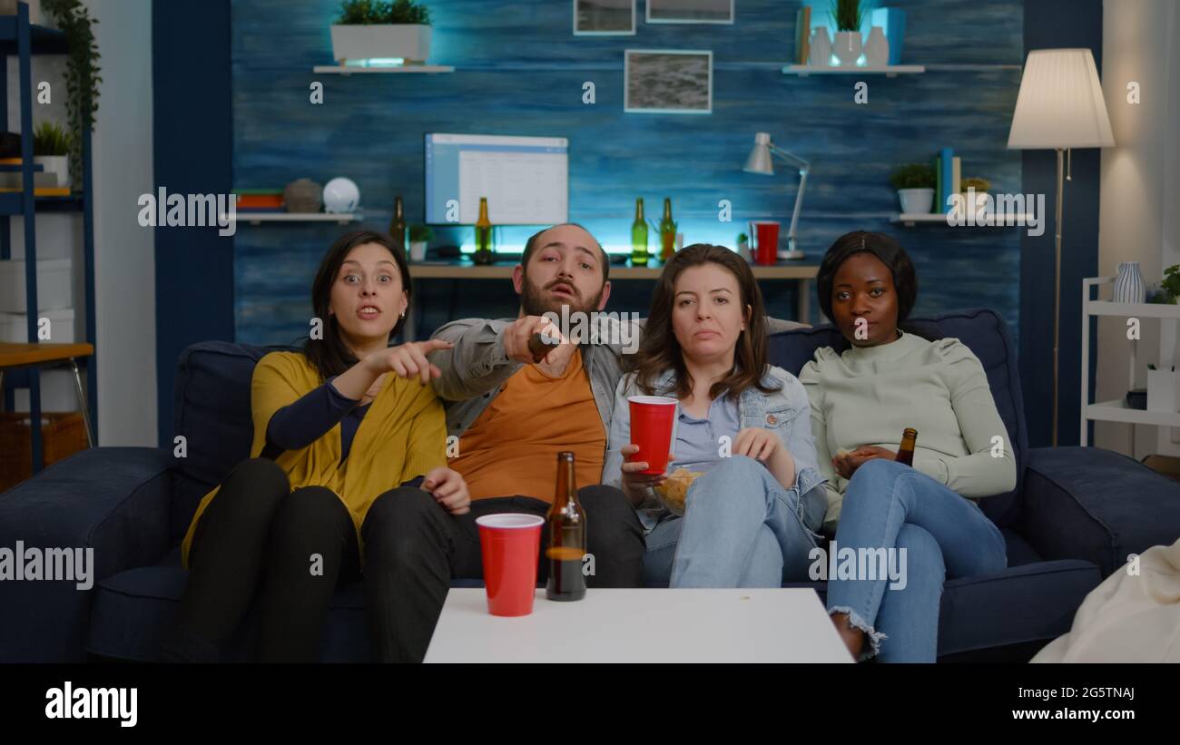 Multi ethnic friends changing channel hi-res stock photography and ...