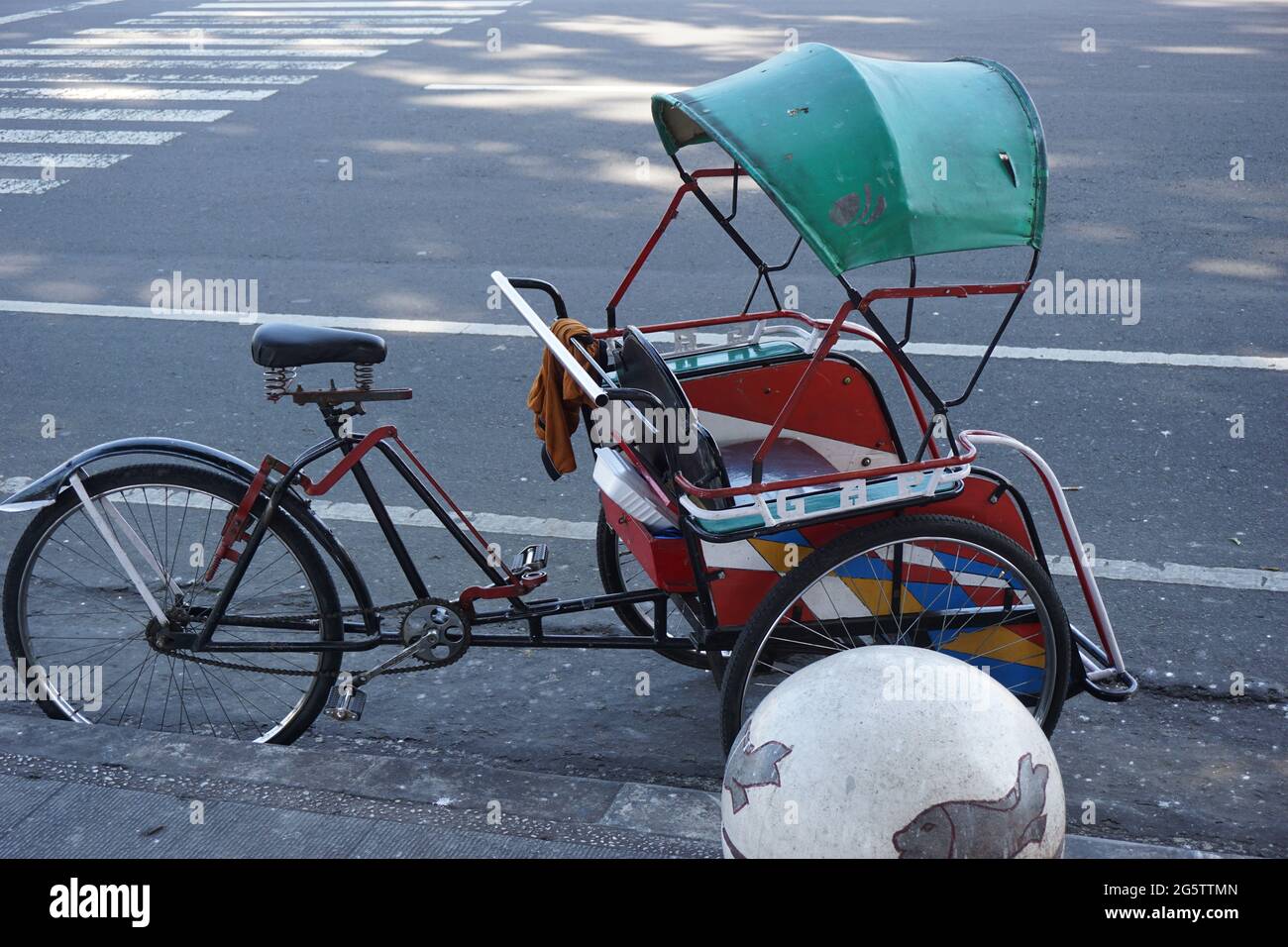Becak on the side walk. Becak is one of traditional indonesian ...