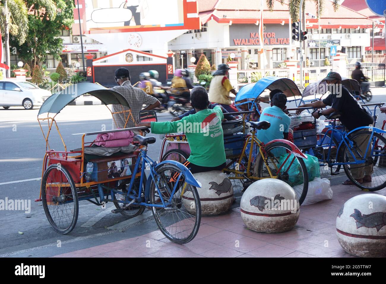 Becak on the side walk. Becak is one of traditional indonesian ...