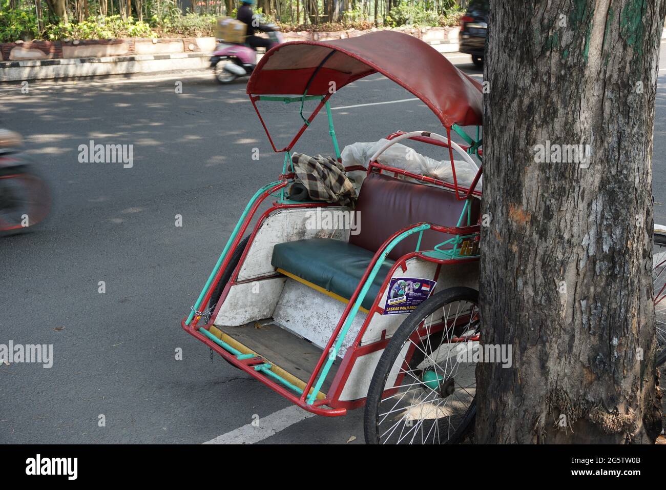 Becak on the side walk. Becak is one of traditional indonesian ...