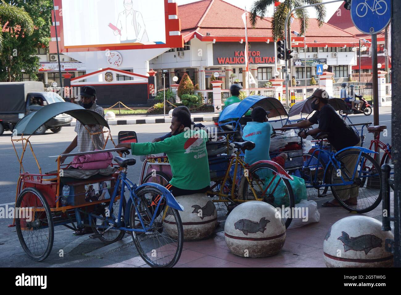 Becak on the side walk. Becak is one of traditional indonesian ...