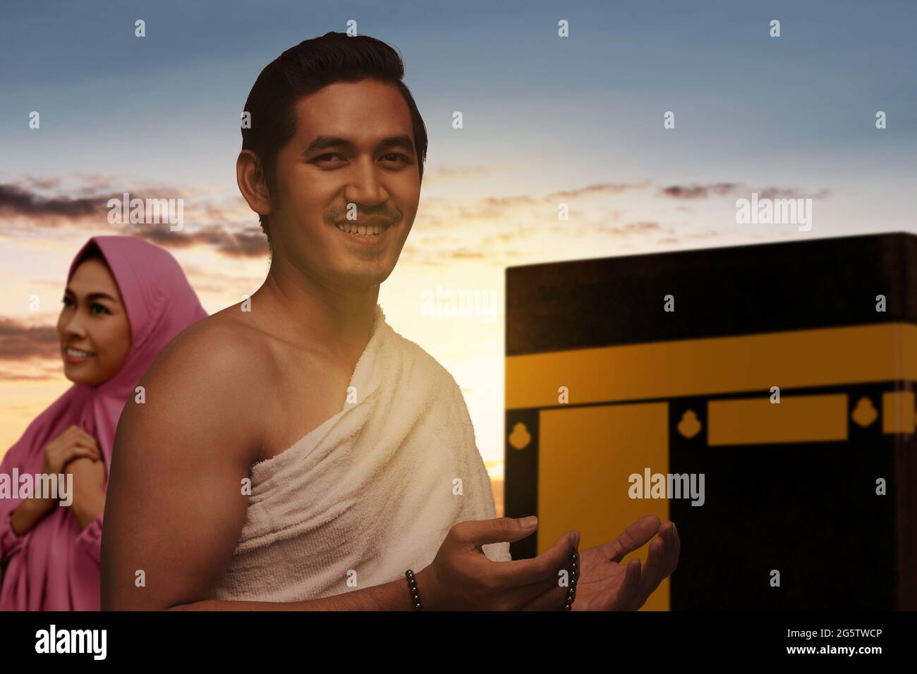 Asian Muslim couple standing and praying with prayer beads with Kaaba ...