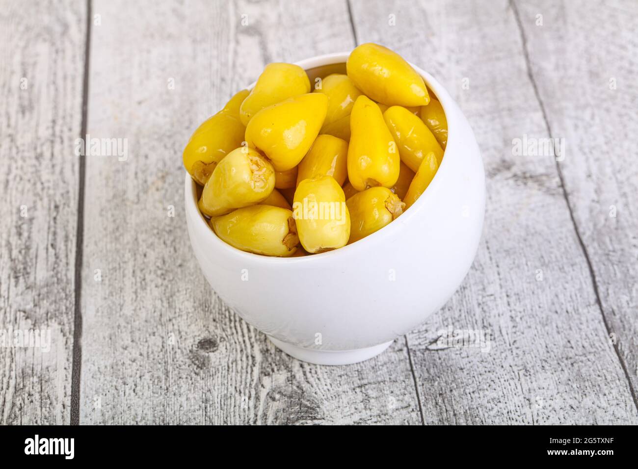 Pickled Yellow spicy mini pepper in the bowl Stock Photo - Alamy