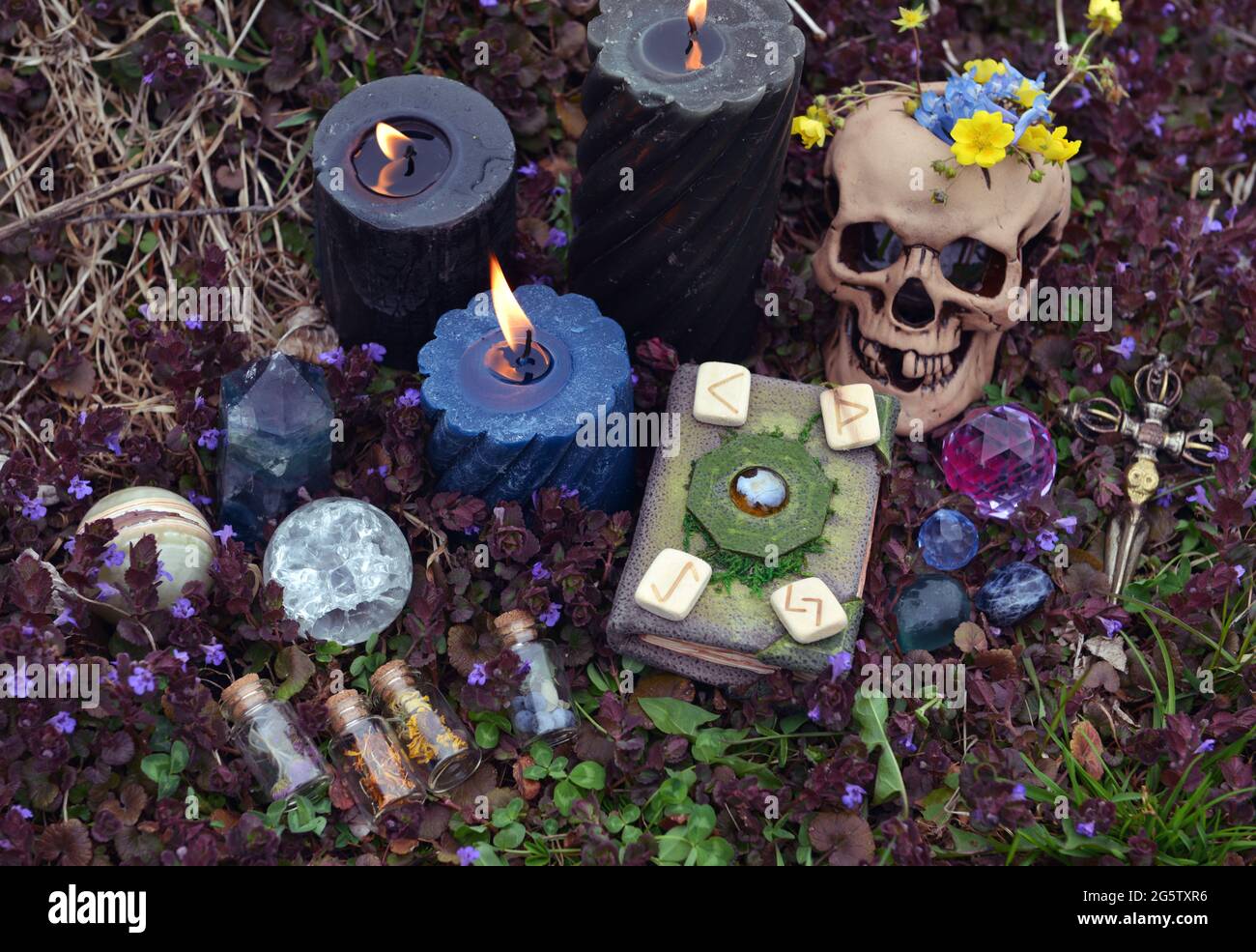 Magic still life with skull, runes, witch book of spells, burning ...