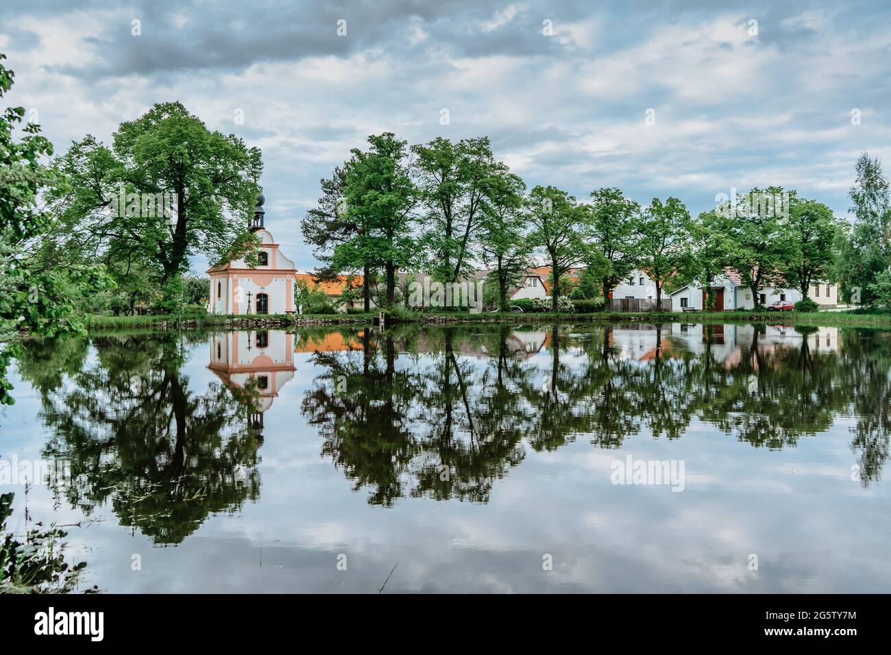 View of pond,houses and rural chapel in small village of Pistina,south ...