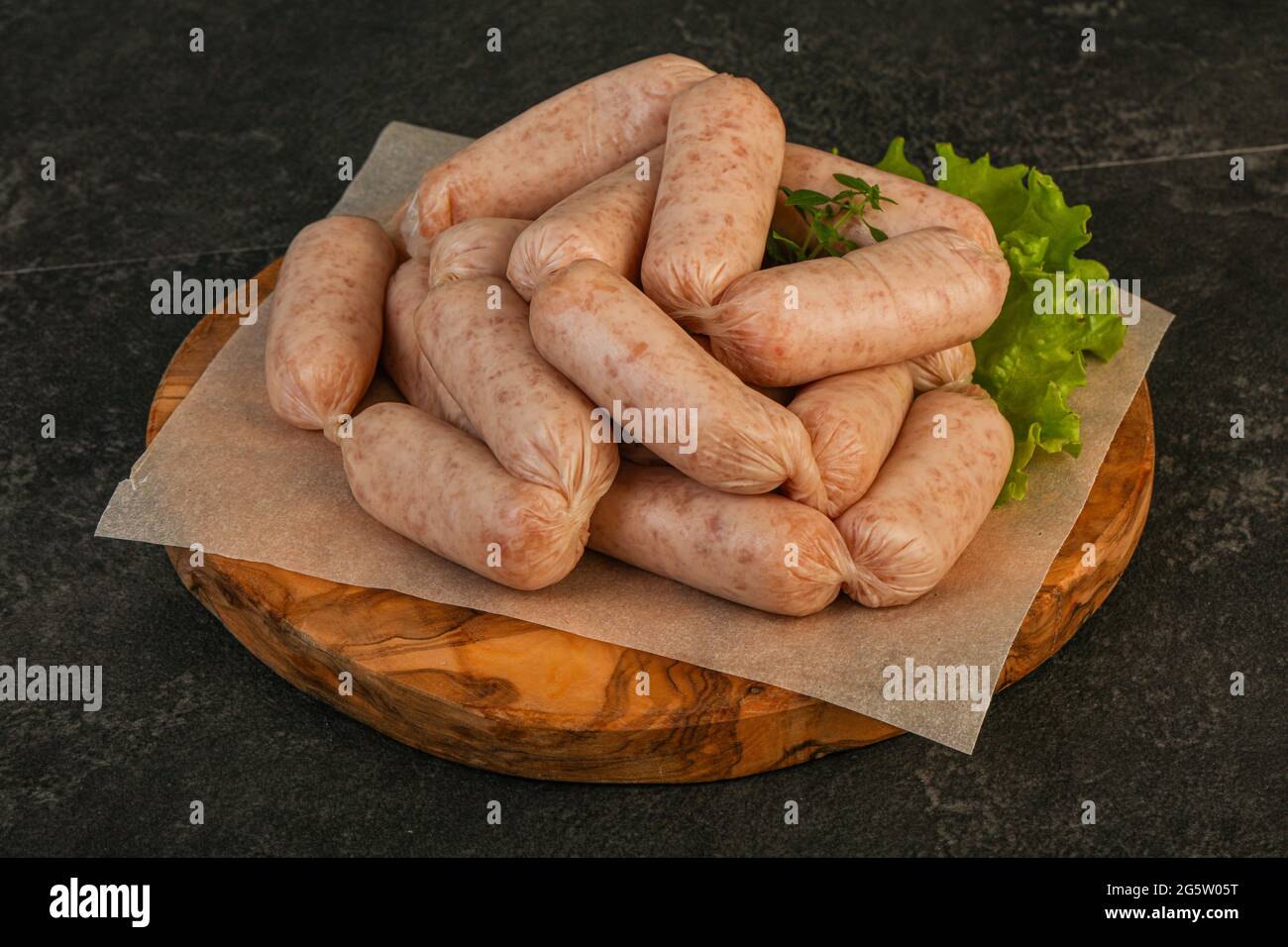 Raw natural chicken baby sausages for roast Stock Photo - Alamy