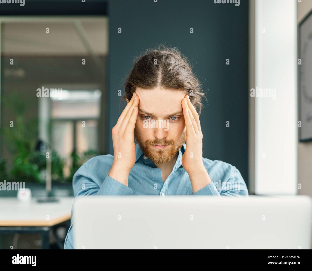 Focused male company employee trying to concentrate Stock Photo - Alamy