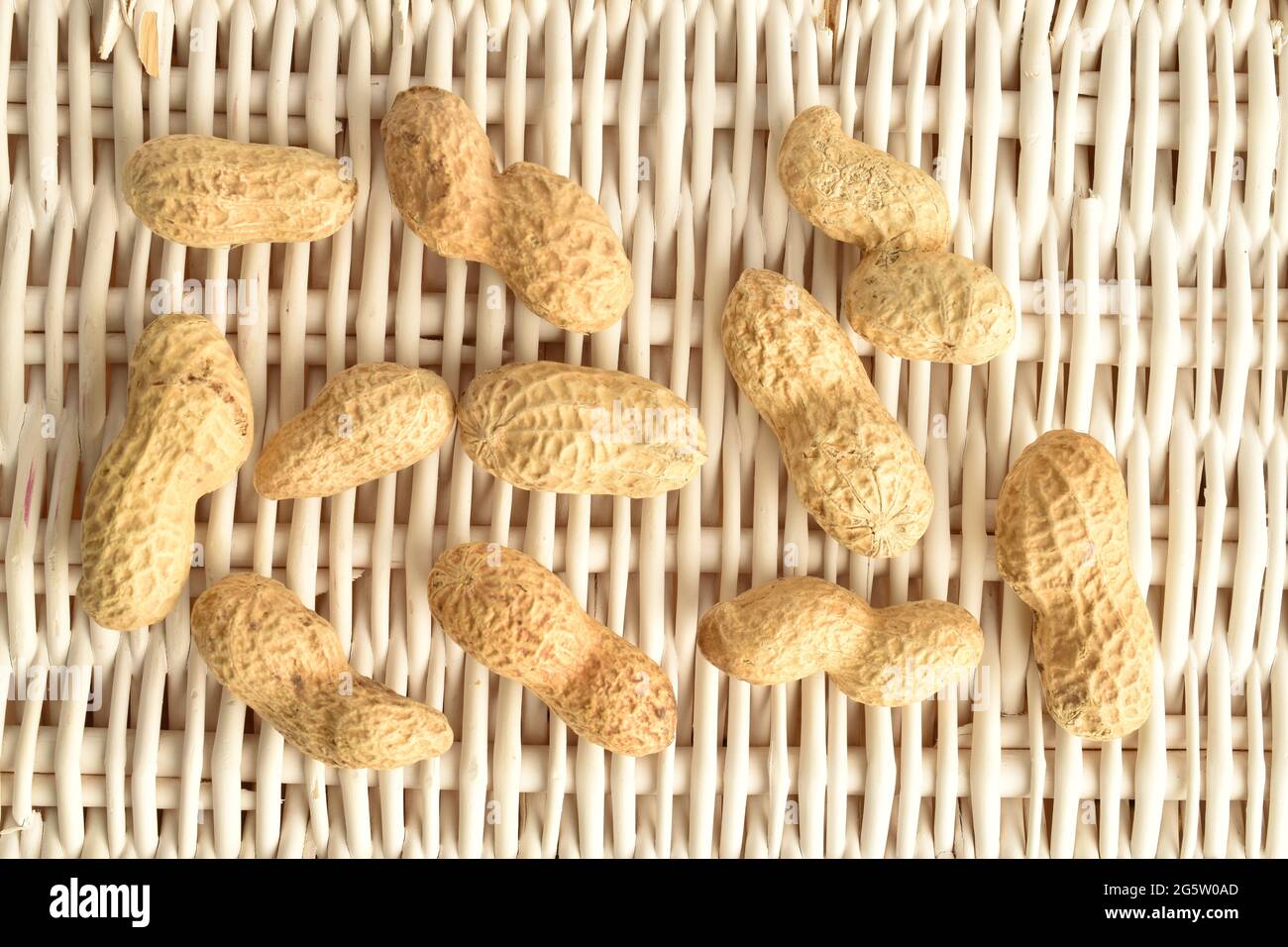 Ripe unpeeled peanuts on a wicker vine tray, close-up, top view Stock ...