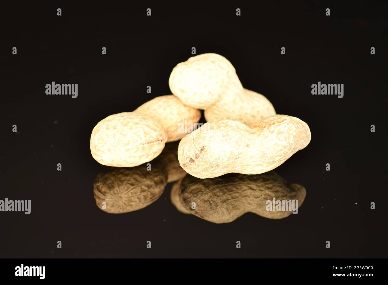 Ripe unpeeled peanuts, close-up, isolated on black background Stock ...