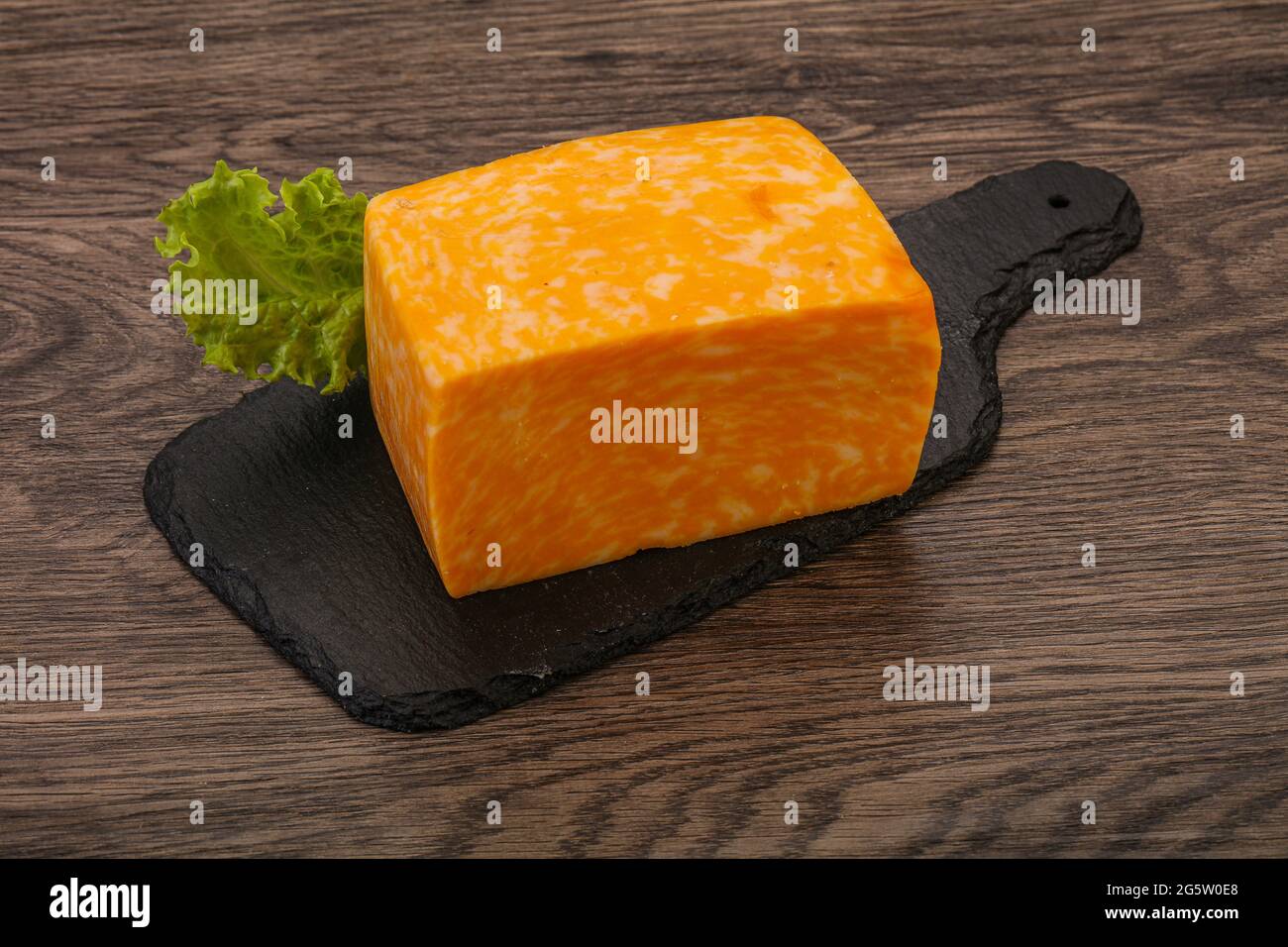Dairy Marble cheese brick over board Stock Photo - Alamy