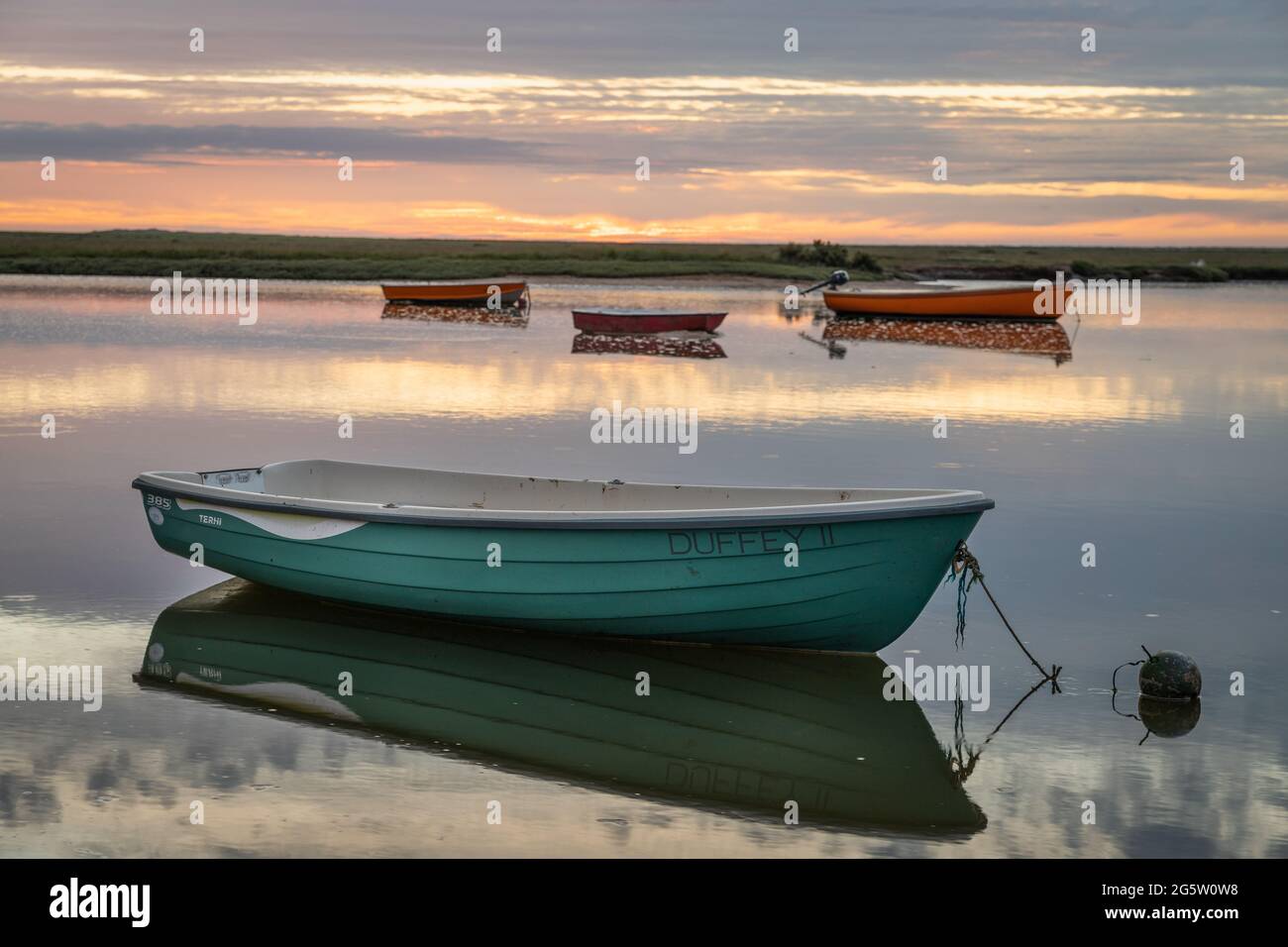 Beautiful small boats during peaceful sunset over the sea water Stock ...