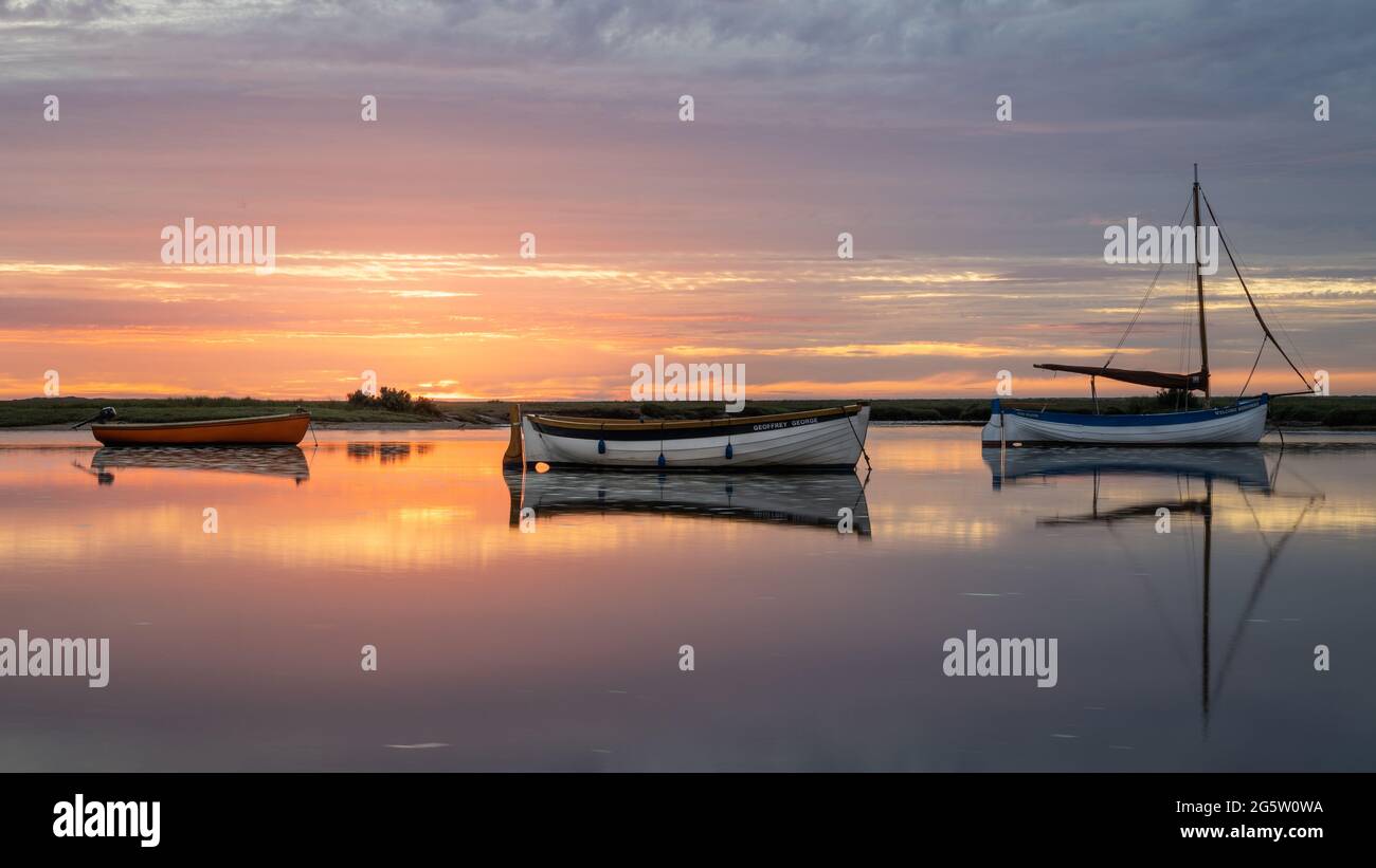 Beautiful small boats during peaceful sunset over the sea water Stock ...