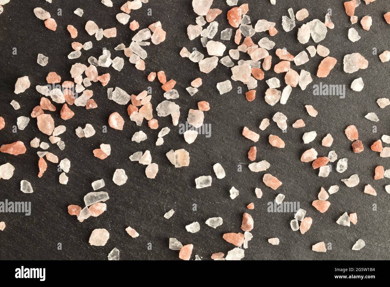 Pink rock salt, close-up, on a slate board, top view Stock Photo - Alamy