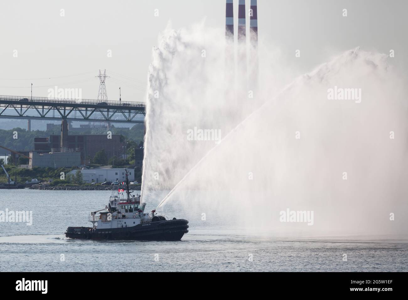 tugboat using fire fighting cannons to say goodbye to RMS Queen Mary 2 ...