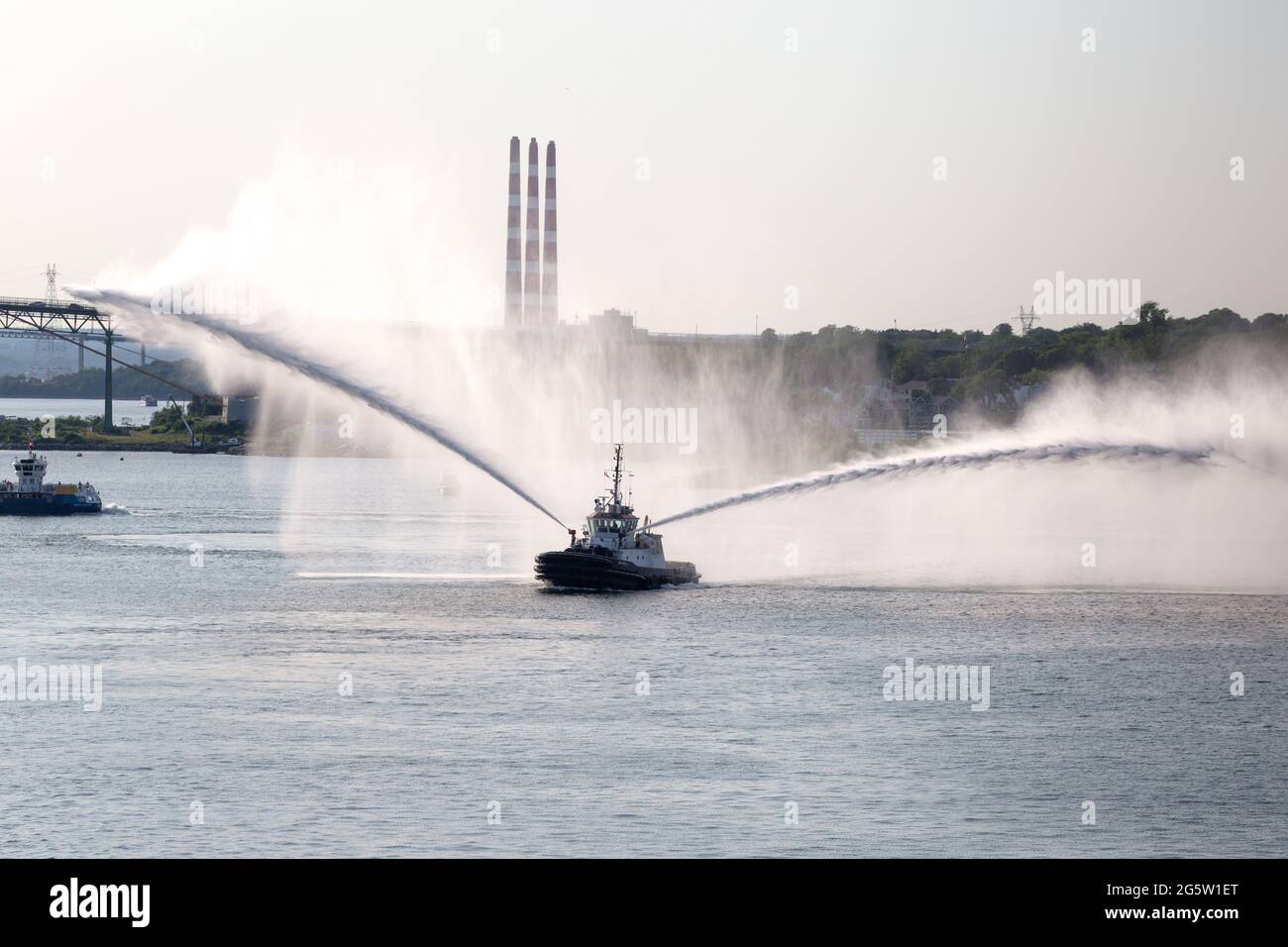 tugboat using fire fighting cannons to say goodbye to RMS Queen Mary 2 ...
