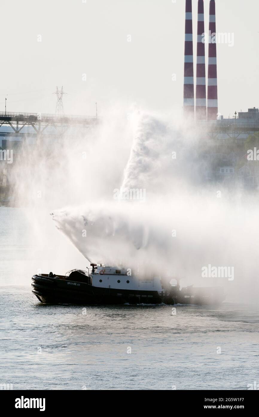 tugboat using fire fighting cannons to say goodbye to RMS Queen Mary 2 ...