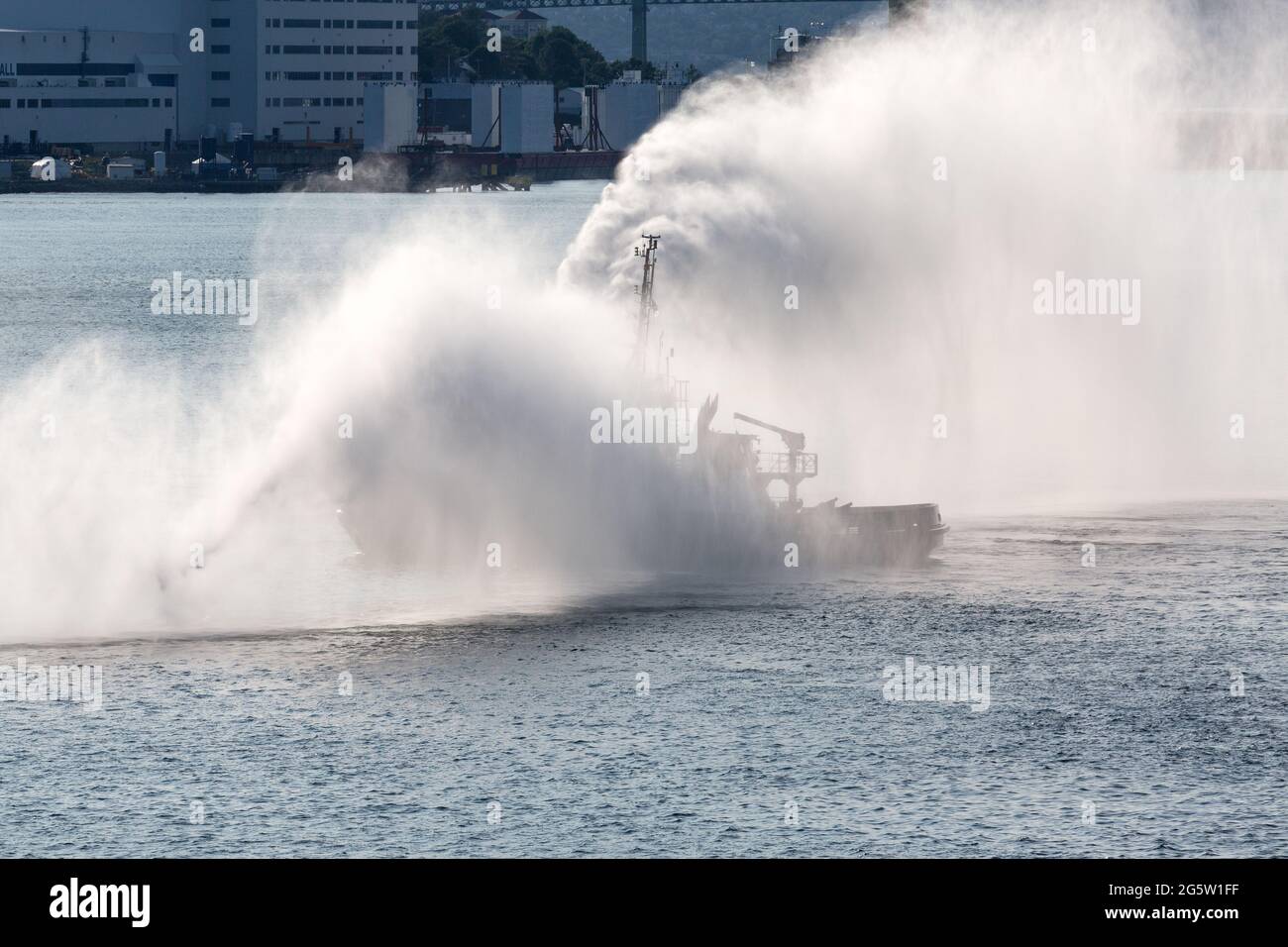 tugboat using fire fighting cannons to say goodbye to RMS Queen Mary 2 ...