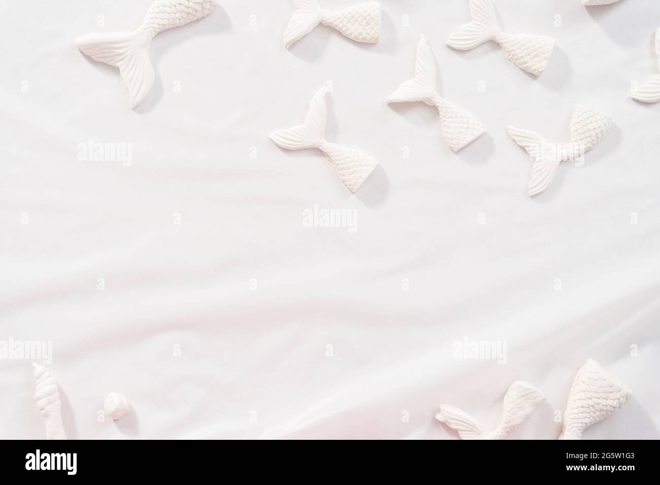 Flat lay. Modeling mermaid tails with white air-dry modeling clay Stock ...