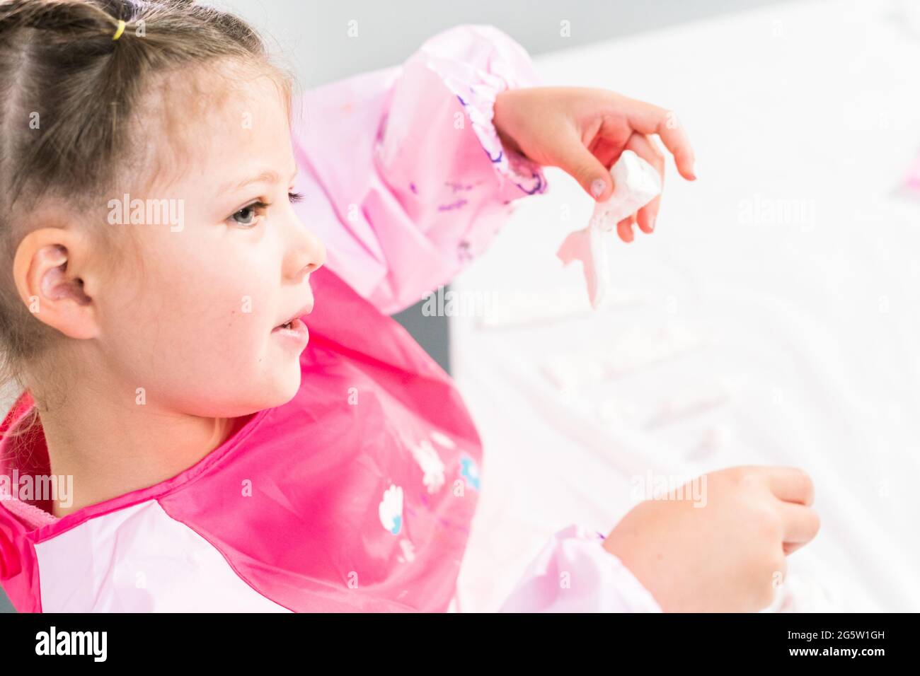 Little girl modeling mermaid tails with white air-dry modeling clay ...
