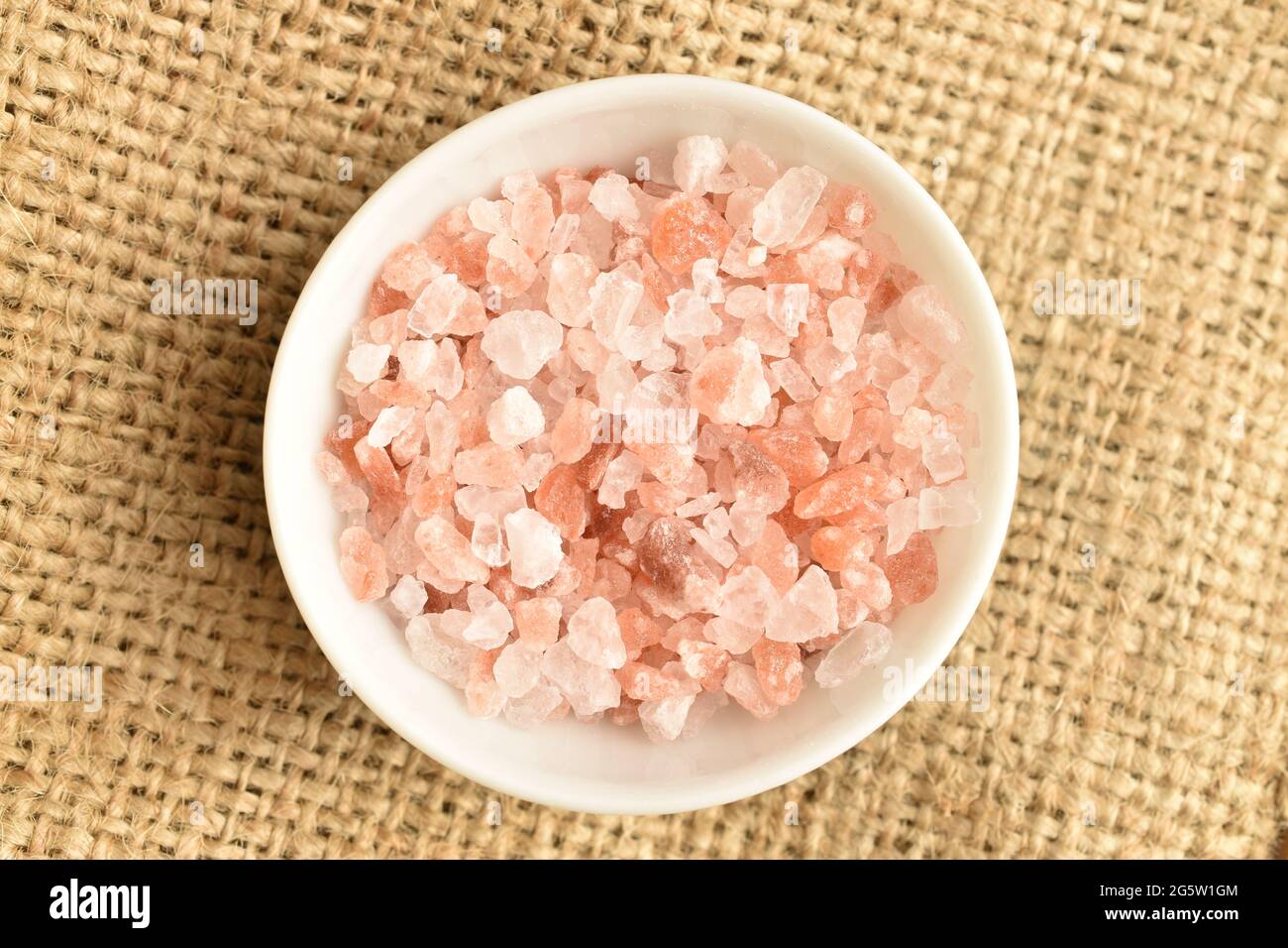 Rock salt in a salt shaker, close-up, on a jute fabric, top view Stock ...