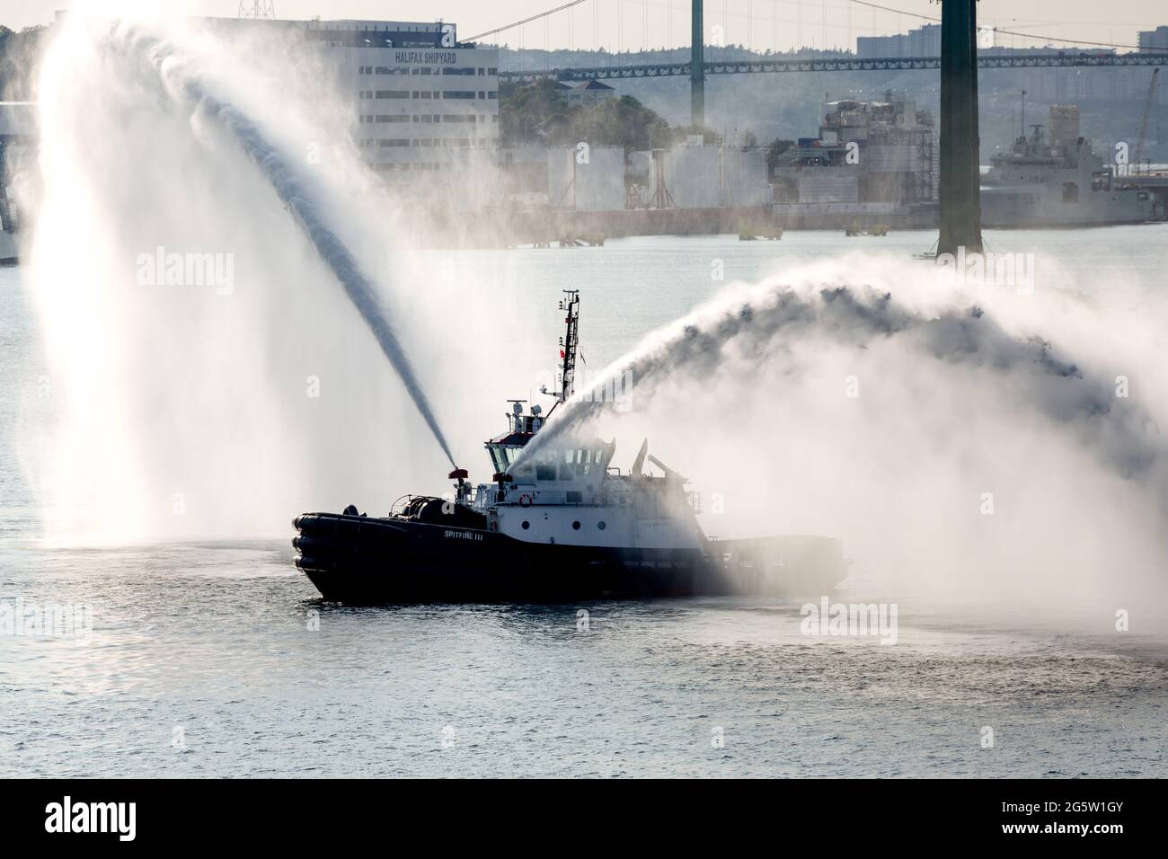tugboat using fire fighting cannons to say goodbye to RMS Queen Mary 2 ...