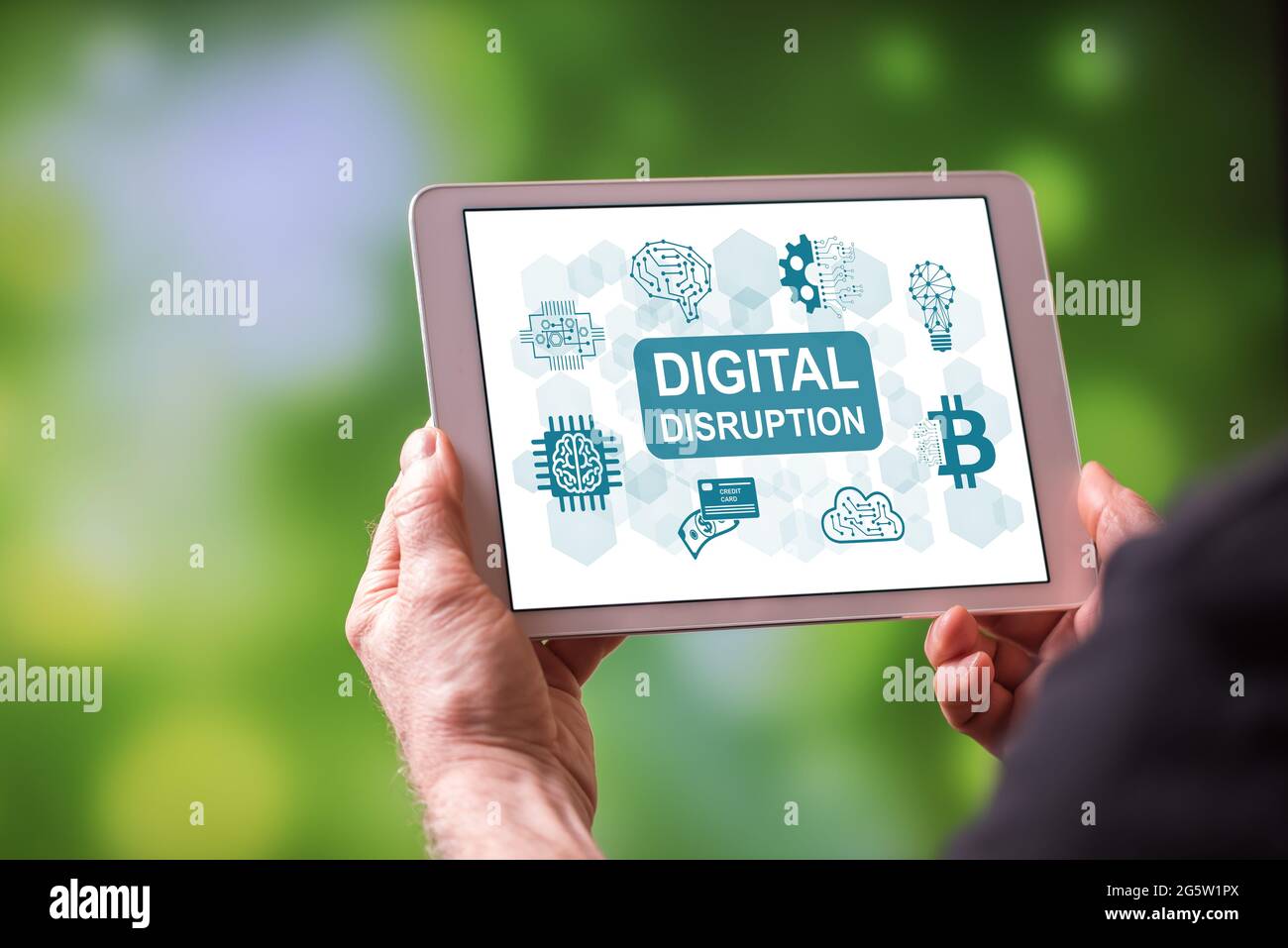 Man holding a tablet showing digital disruption concept Stock Photo - Alamy