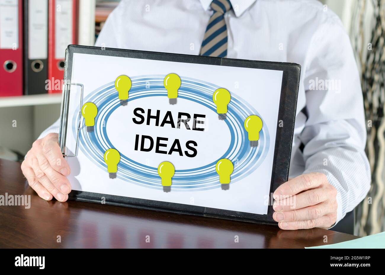 Share ideas concept shown by a businessman Stock Photo - Alamy