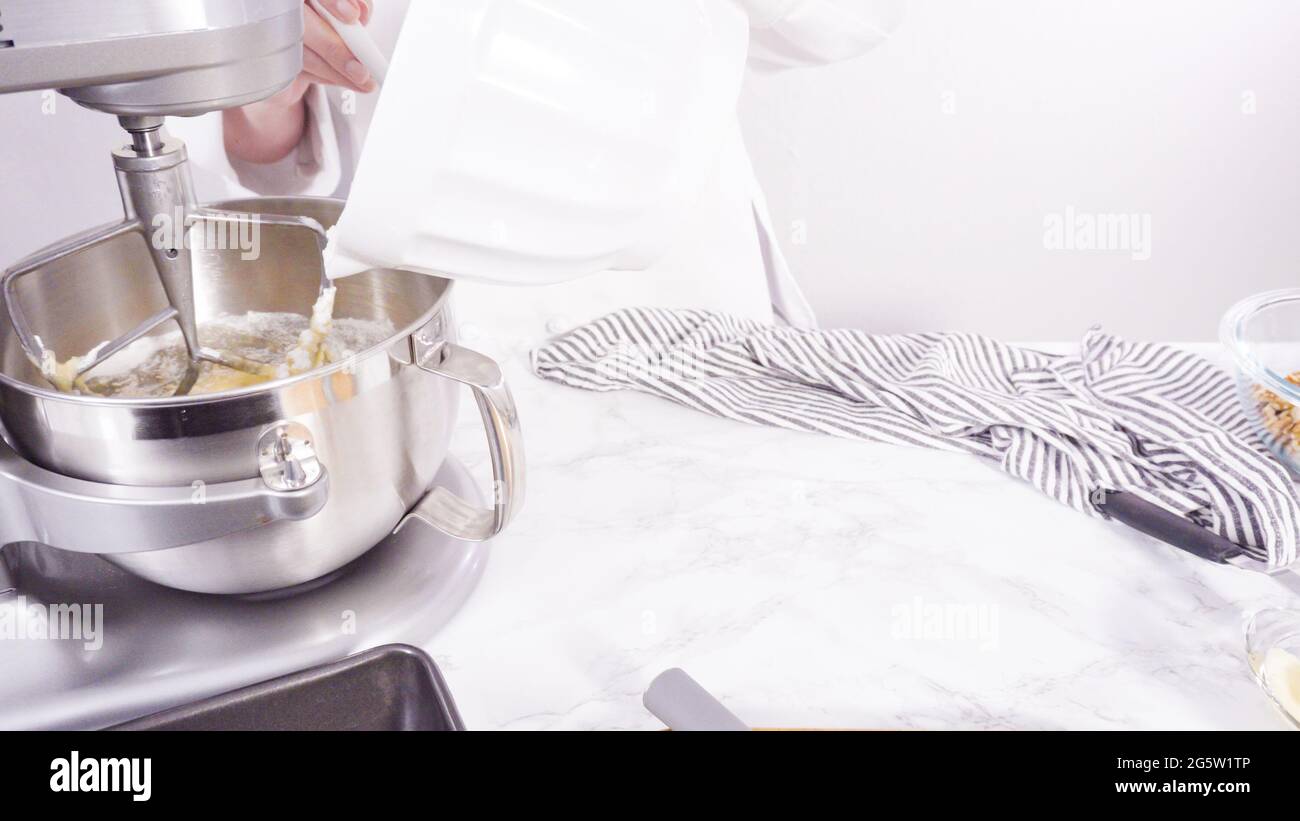 Step by step. Mixing ingredients together into a metal mixing bowl to ...