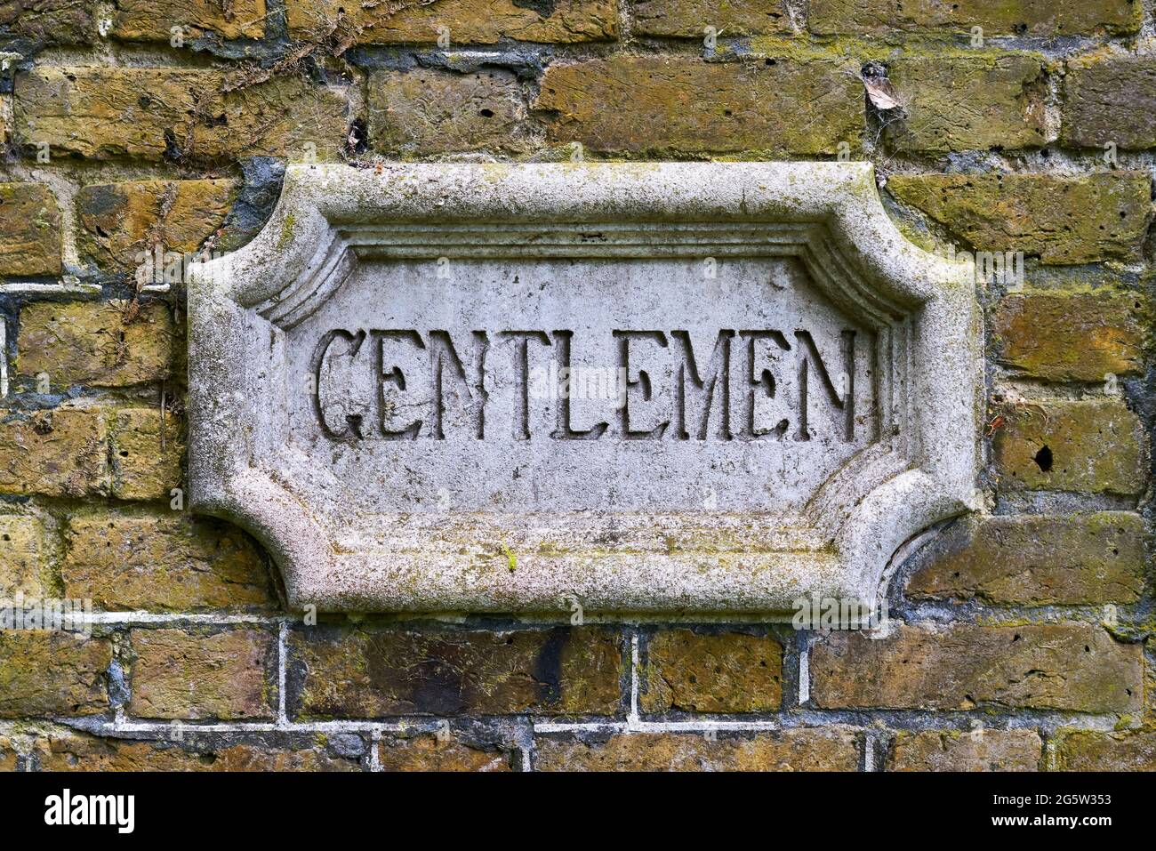 An elaborate sign for the toilet on an external brick wall Stock Photo ...