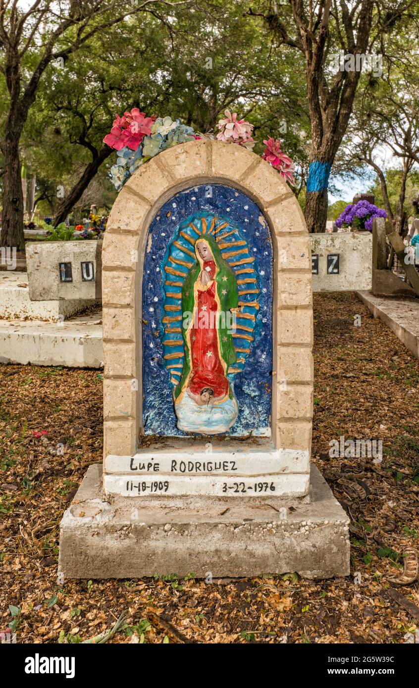 Virgin of Guadalupe carving at grave at historic cemetery in San Benito ...